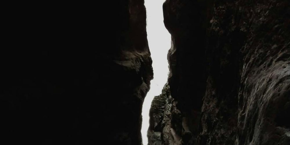 Cave, narrow opening, rock, mountain, 1200x600 - Crossroads Initiative